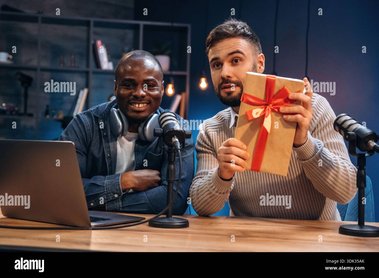 Christmas gift box. Two radio presenters recording an audio broadcast ...