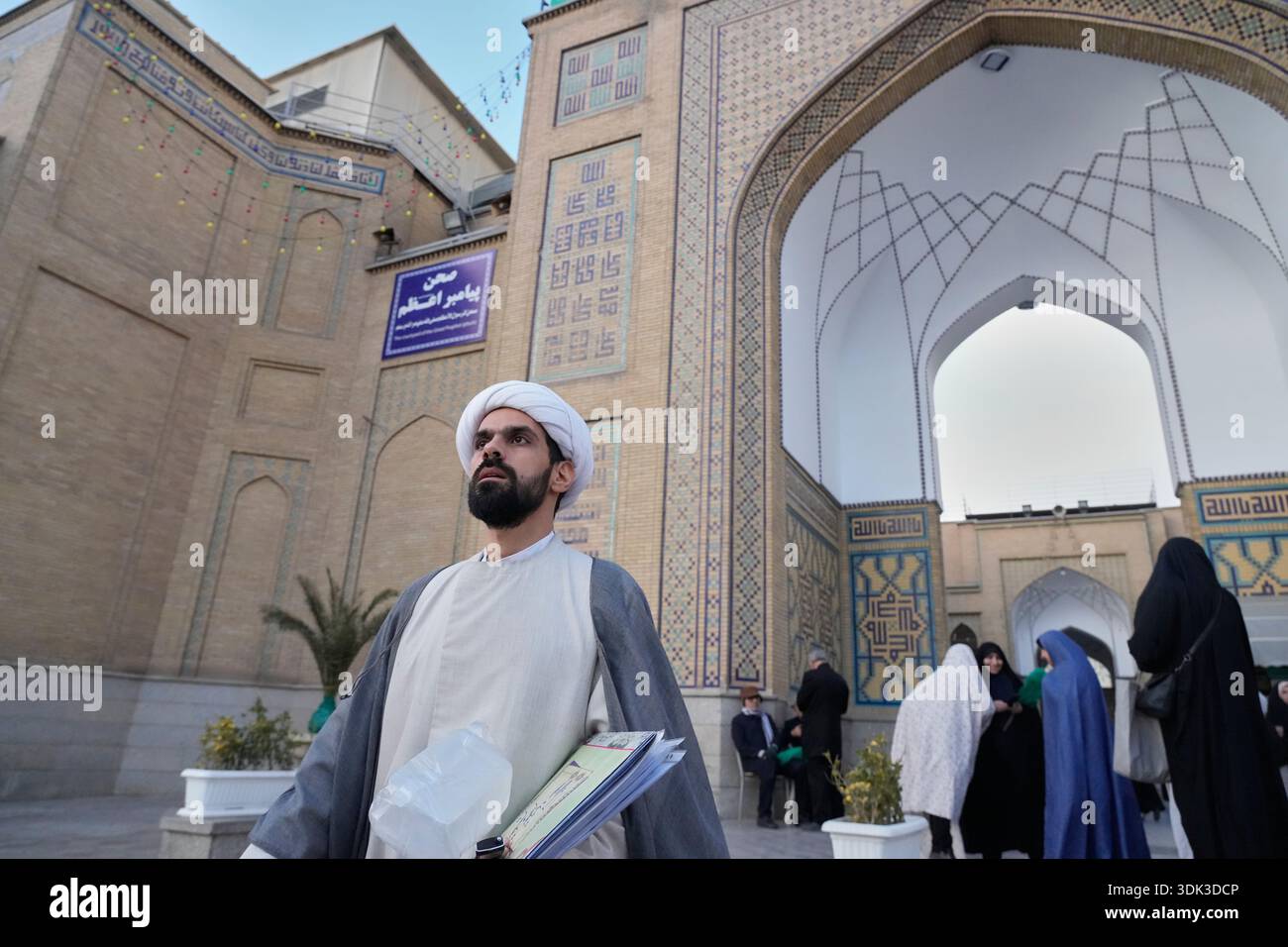 A Shiite Muslim cleric leaves the Saint Abdulazim shrine in Shahr-e-Ray ...