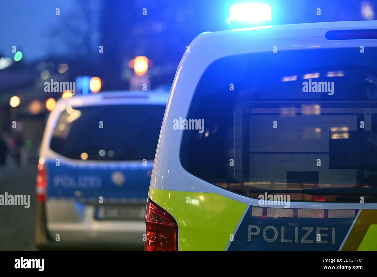 13 January 2026, Berlin: Two police cars with flashing lights at ...