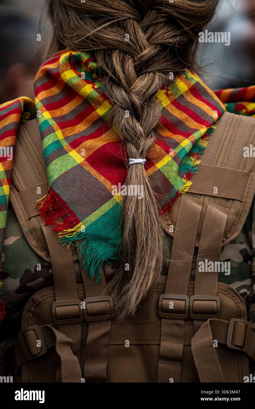 A woman with braided hair during a solidarity demonstration in Erbil ...