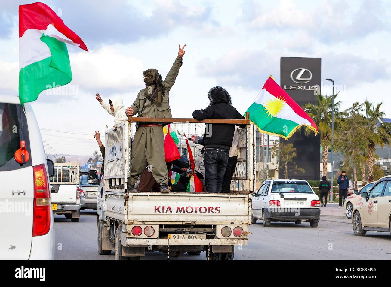 Kurdish protesters wave national flags as they demonstrate in support ...