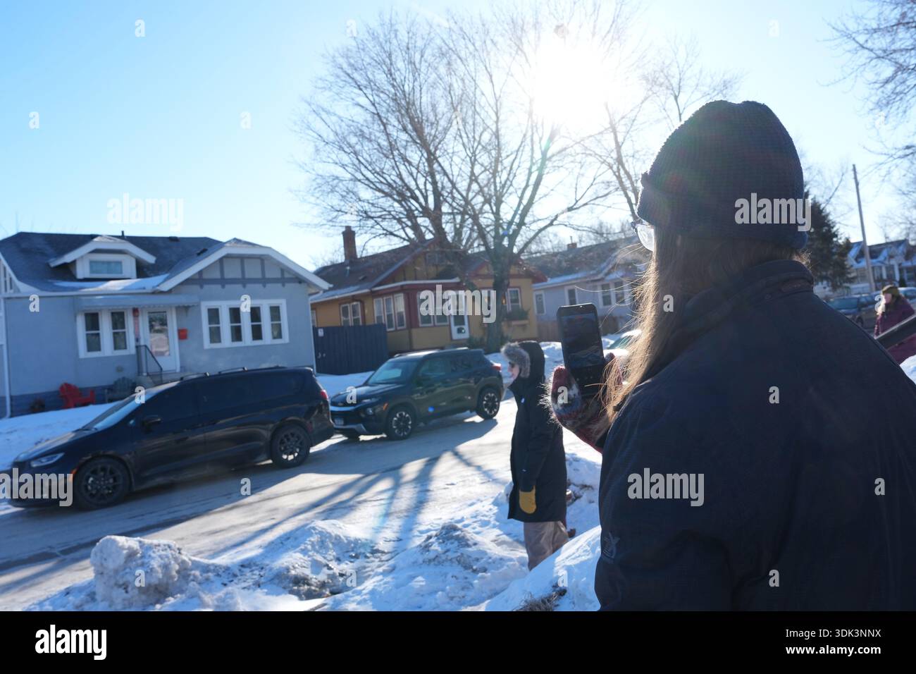 People film federal agents in the area on Thursday, Jan. 29, 2026, in ...