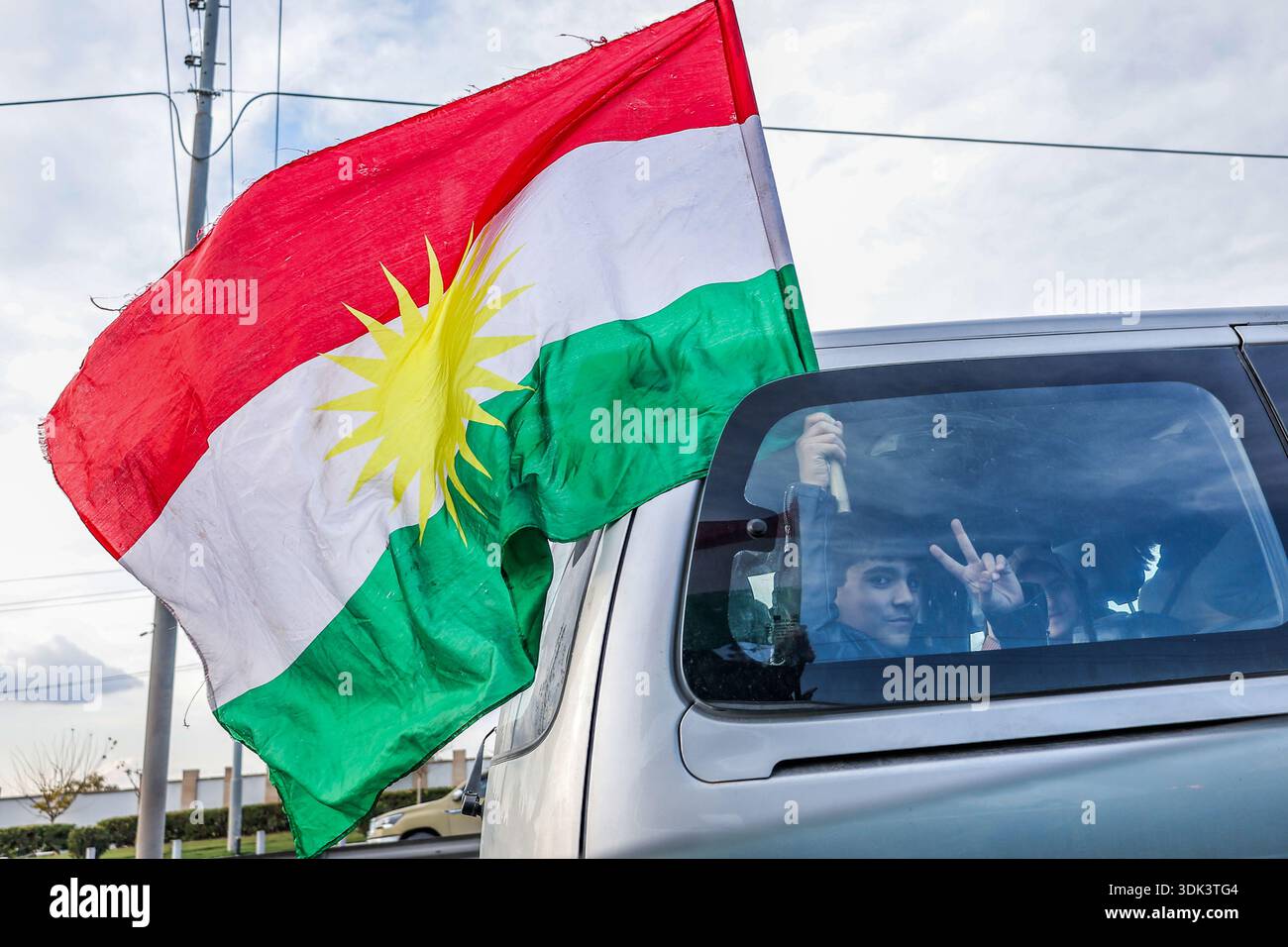 Kurdish protesters wave national flags as they demonstrate in support ...
