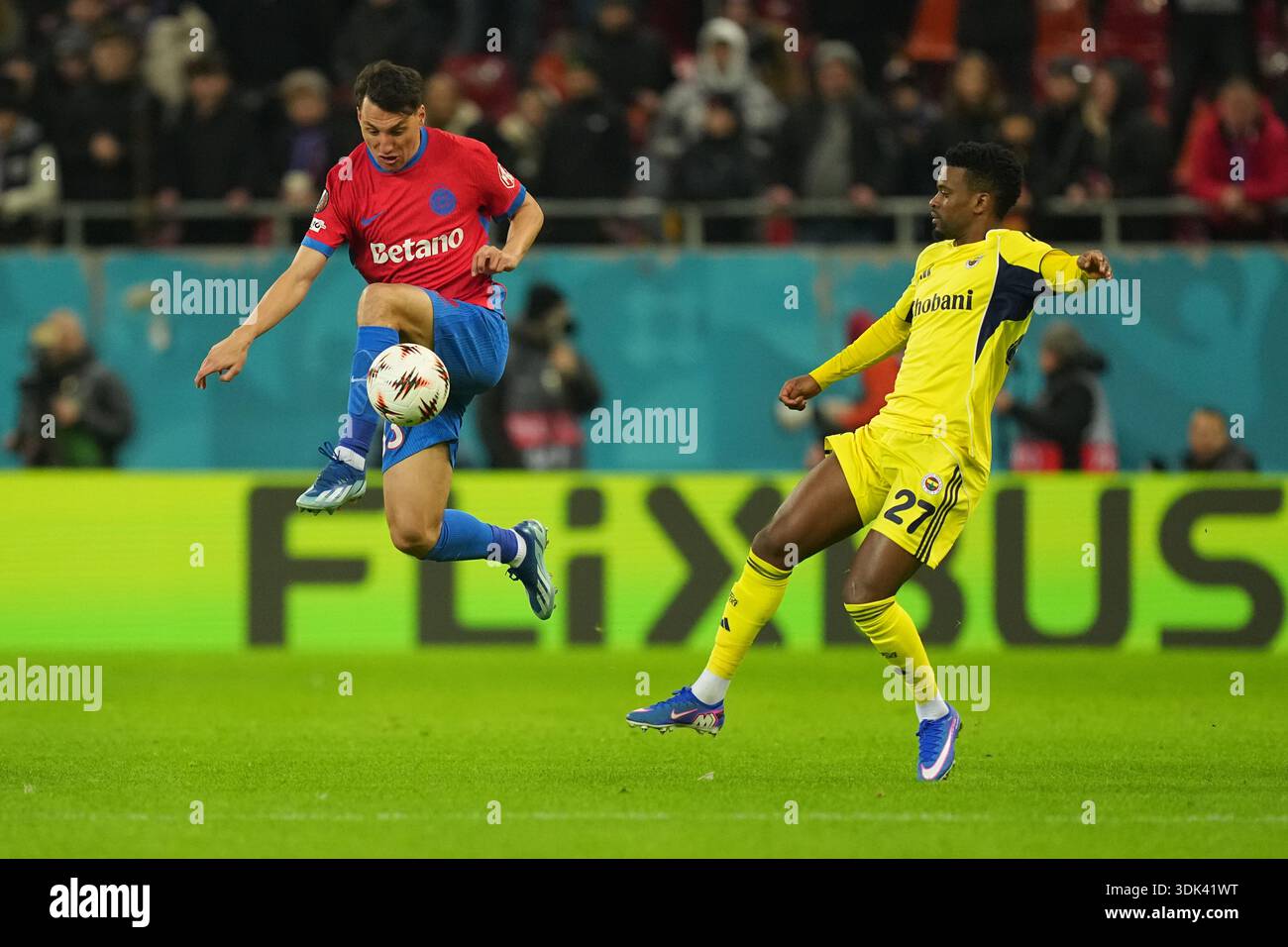 Fenerbahce's Nelson Semedo, right, challenges for the ball with FCSB's ...