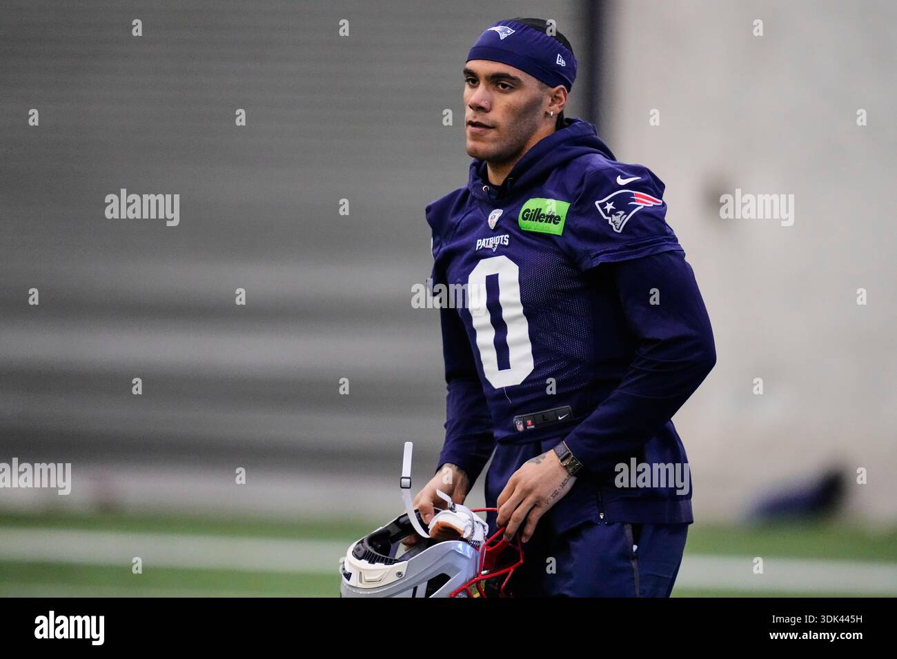 New England Patriots cornerback Christian Gonzalez (0) stretches during ...
