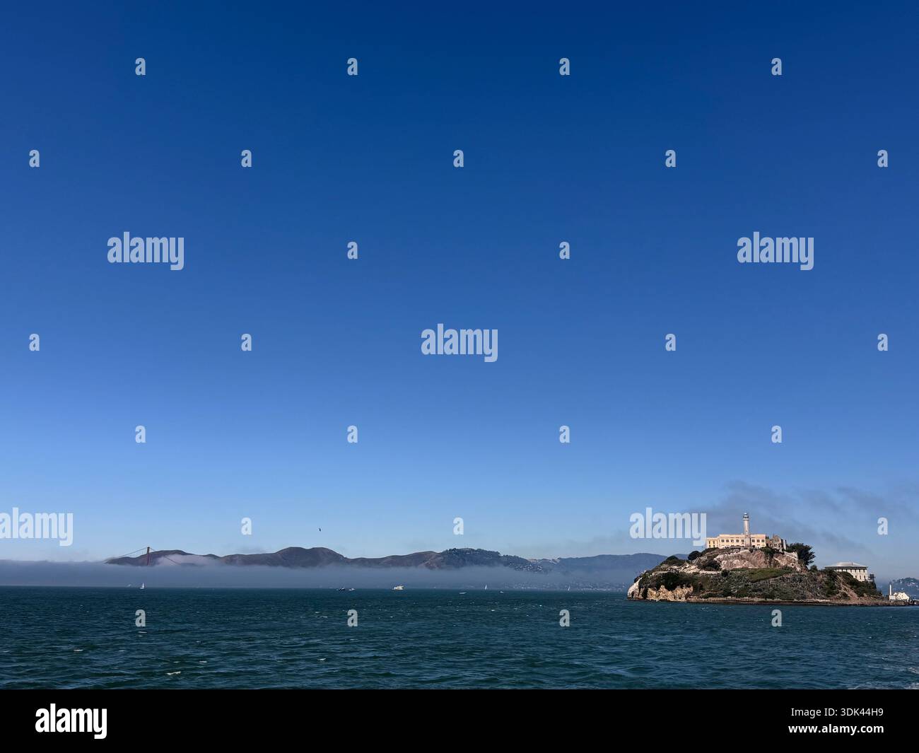 Alcatraz Island prison complex in San Francisco Bay under clear blue ...