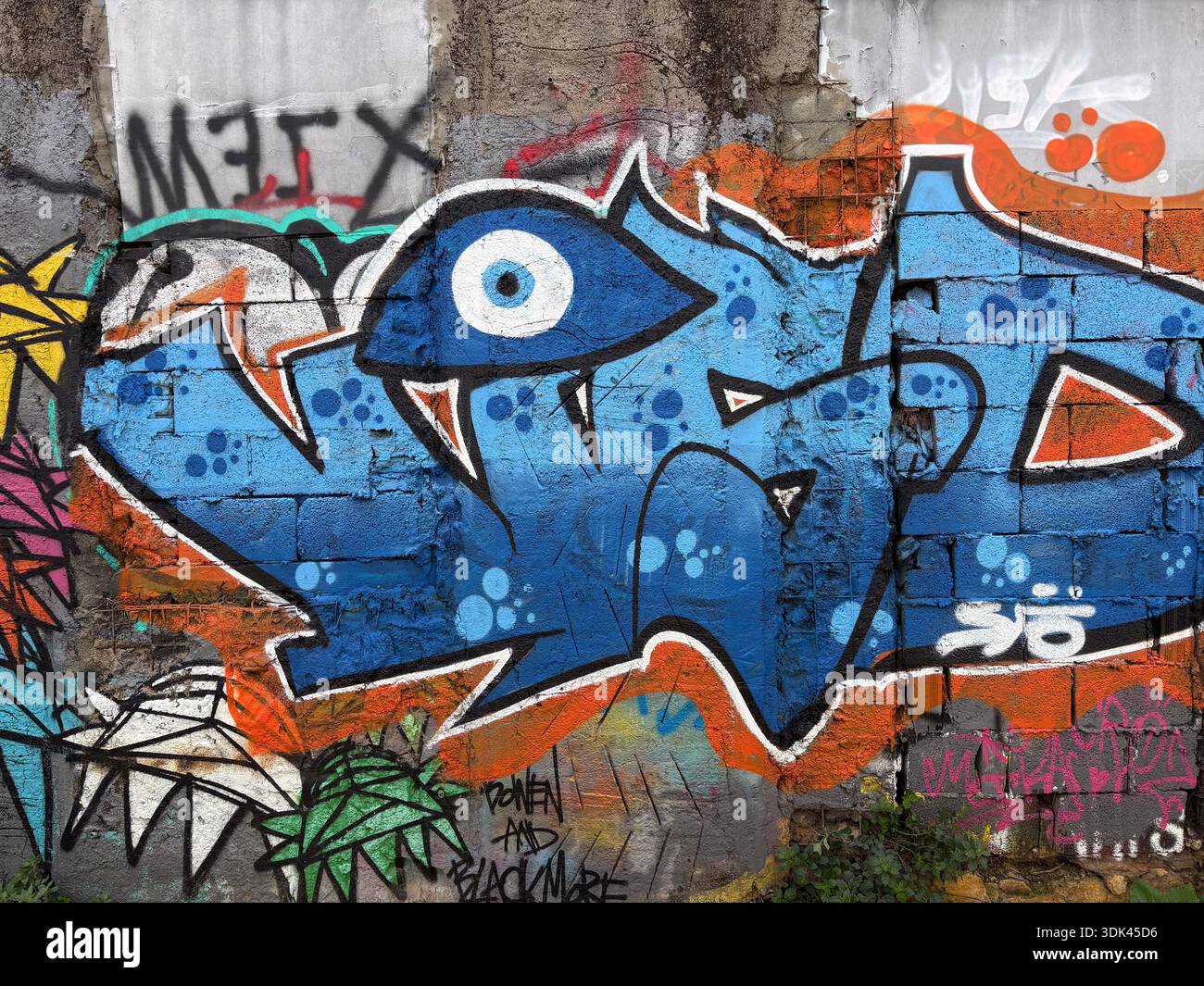 Blue and orange abstract graffiti mural featuring a central evil eye ...