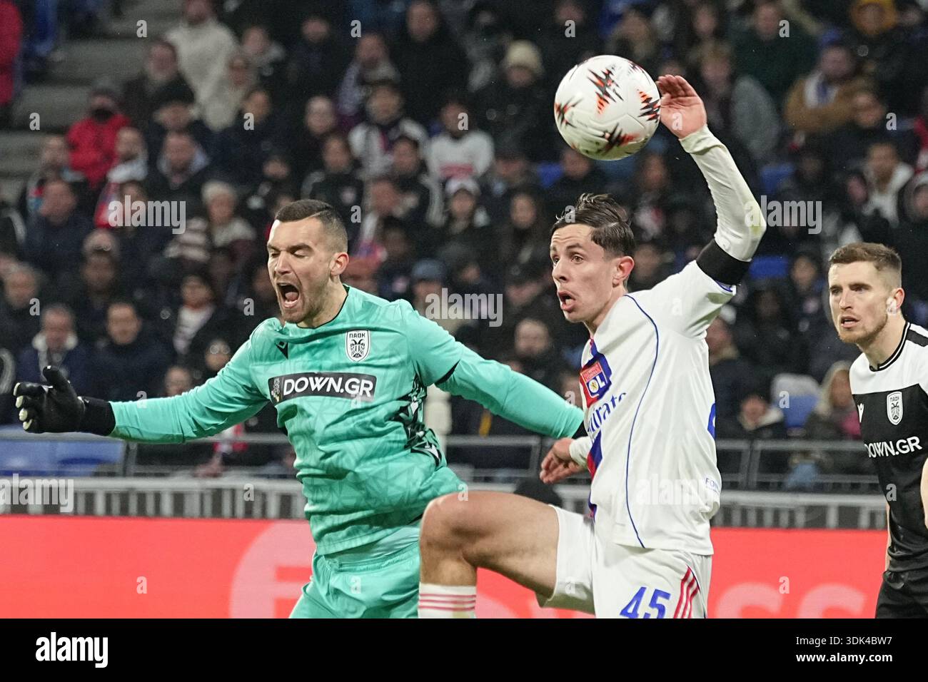 Lyon's Remi Himbert, right, challenges for the ball with PAOK's ...
