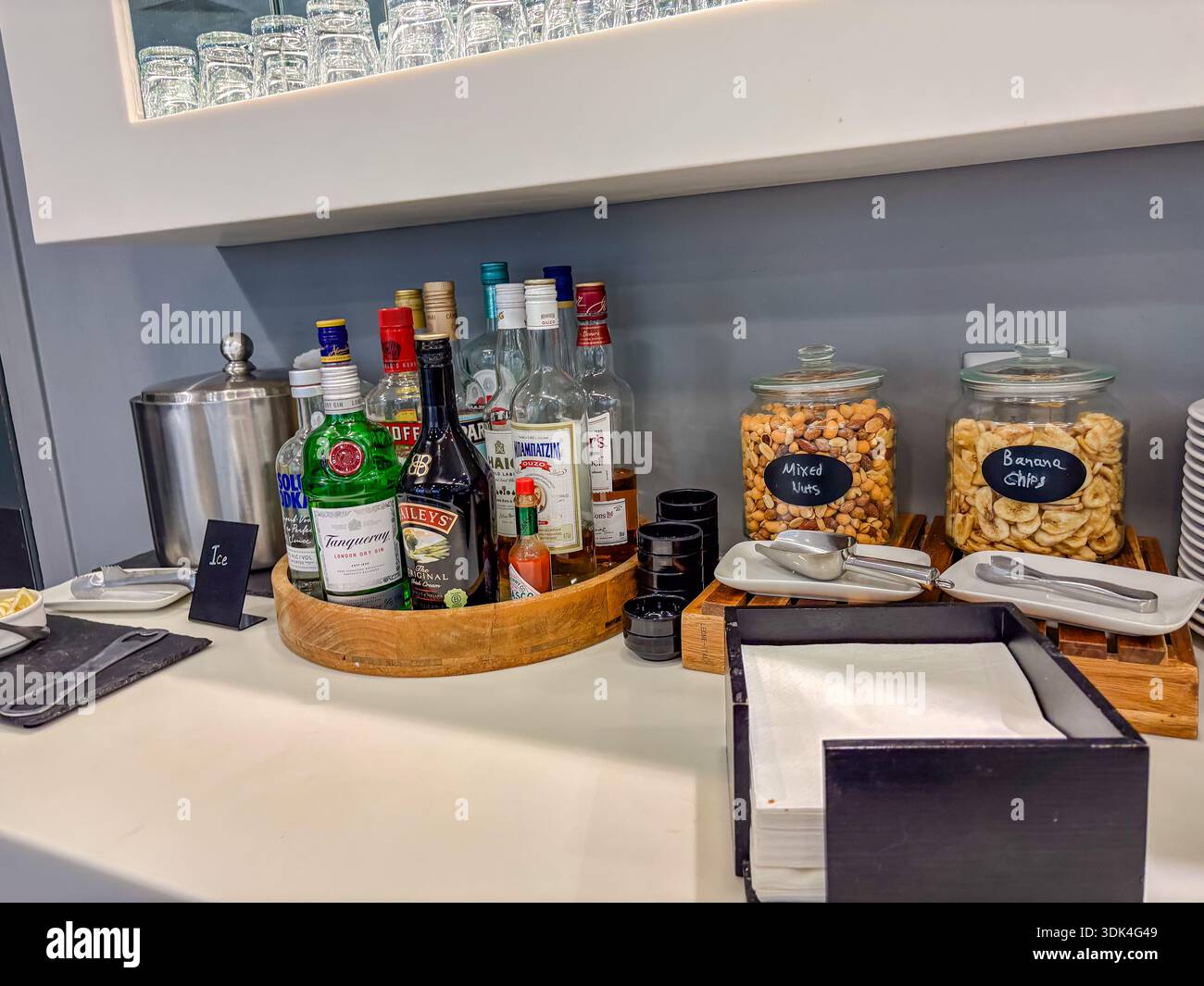 Self service bar station in an airport lounge featuring Tanqueray ...