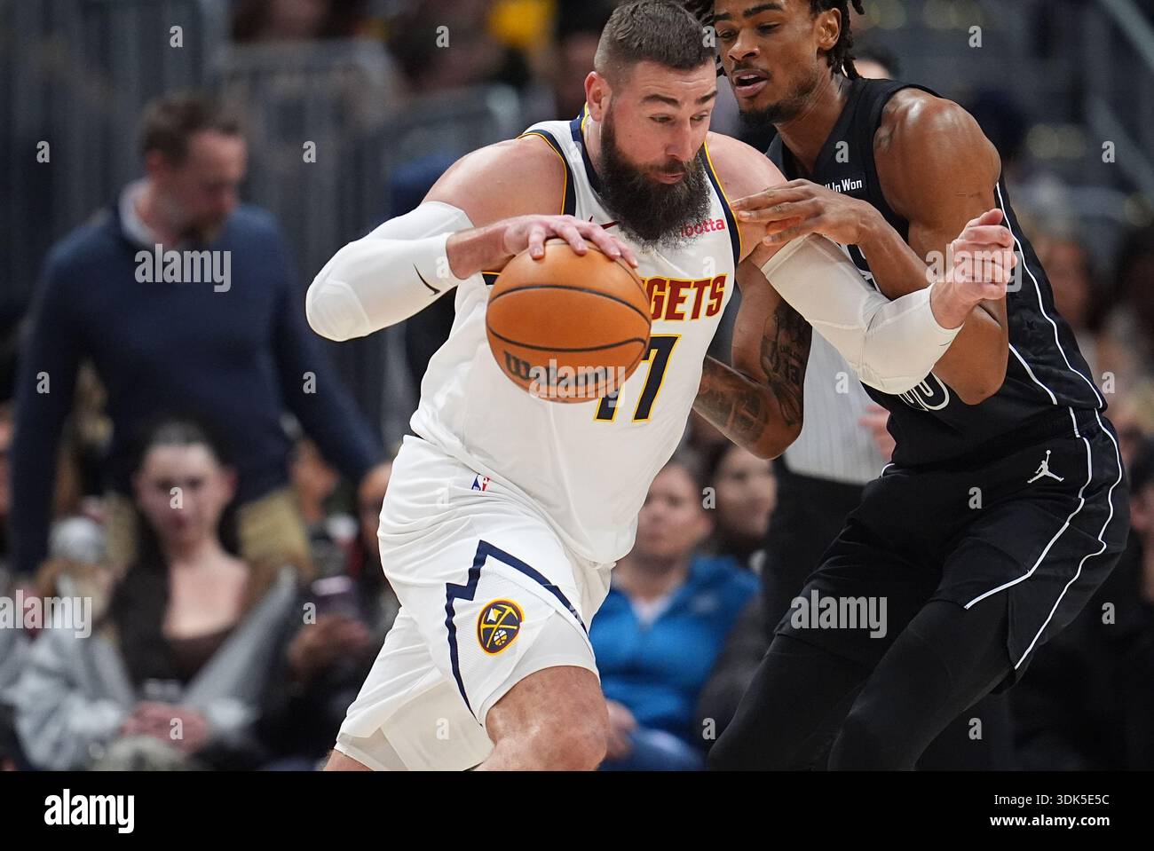 Denver Nuggets center Jonas Valančiūnas, front, drives past Brooklyn ...
