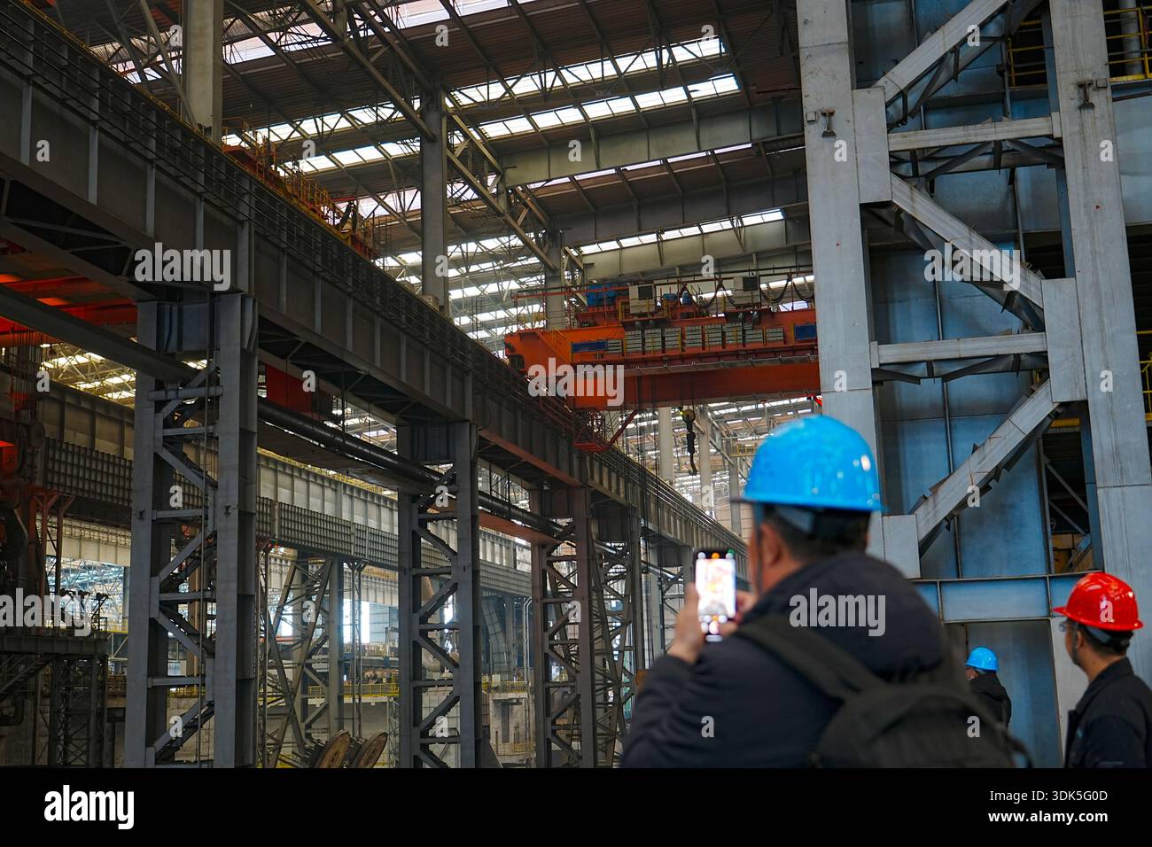 Steel mill workers command their work during operations Stock Photo - Alamy