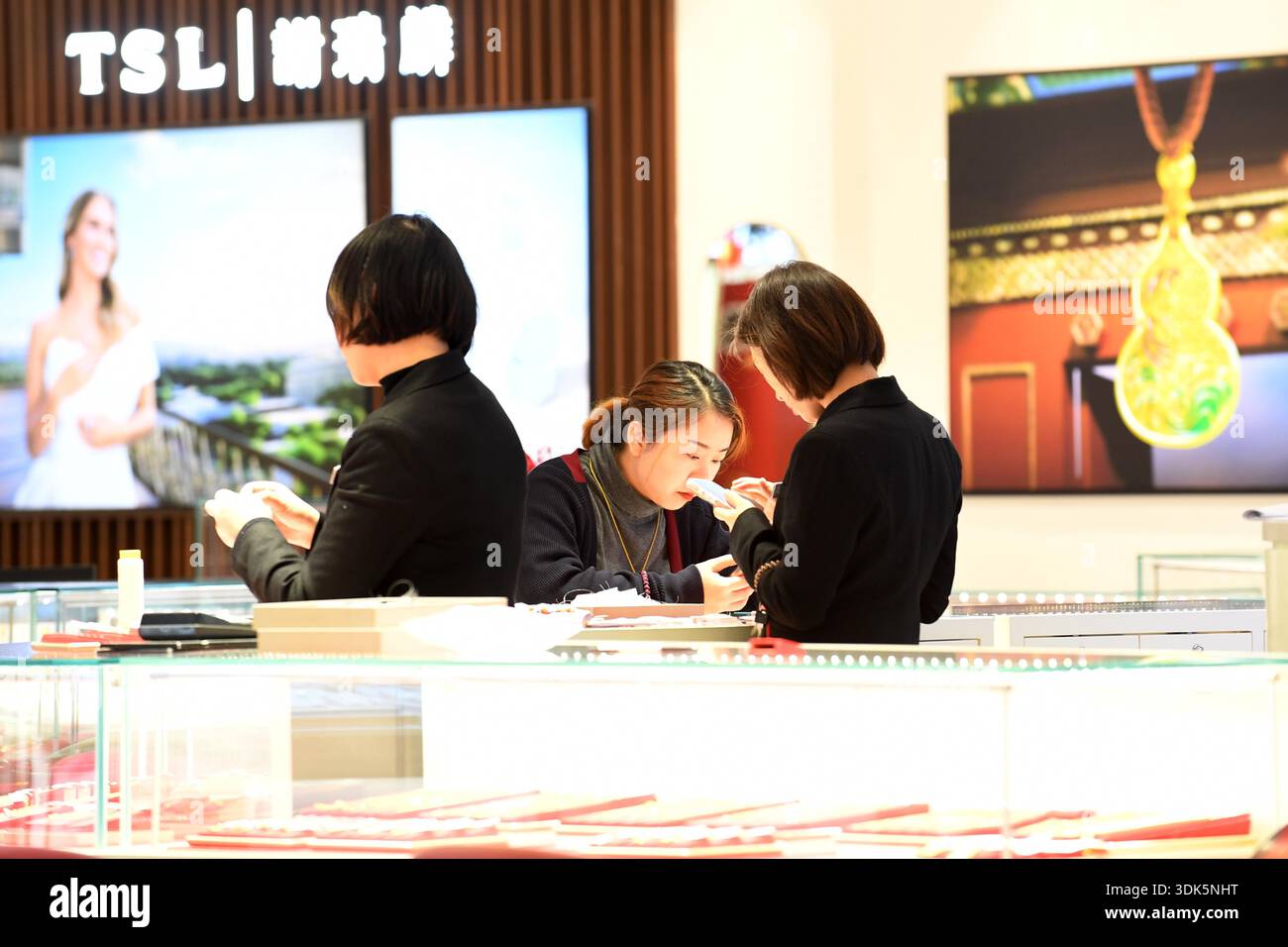 Customers selects gold jewelry at a store in Renhuai City, southwest ...