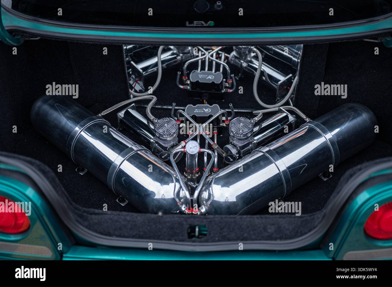 A closeup of a custom chrome air suspension system installed in the ...
