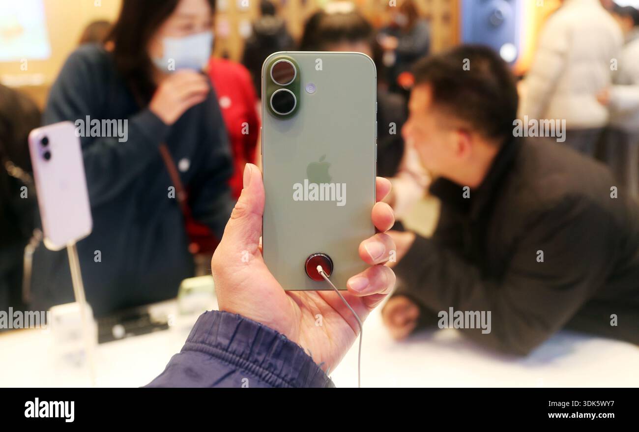 A consumer experiences the iPhone 17 Standard Edition smartphone in the ...