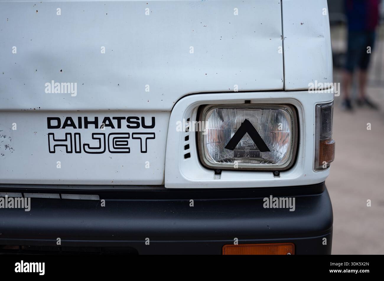 A detailed close-up of a white Daihatsu Hijet kei truck. This charming ...