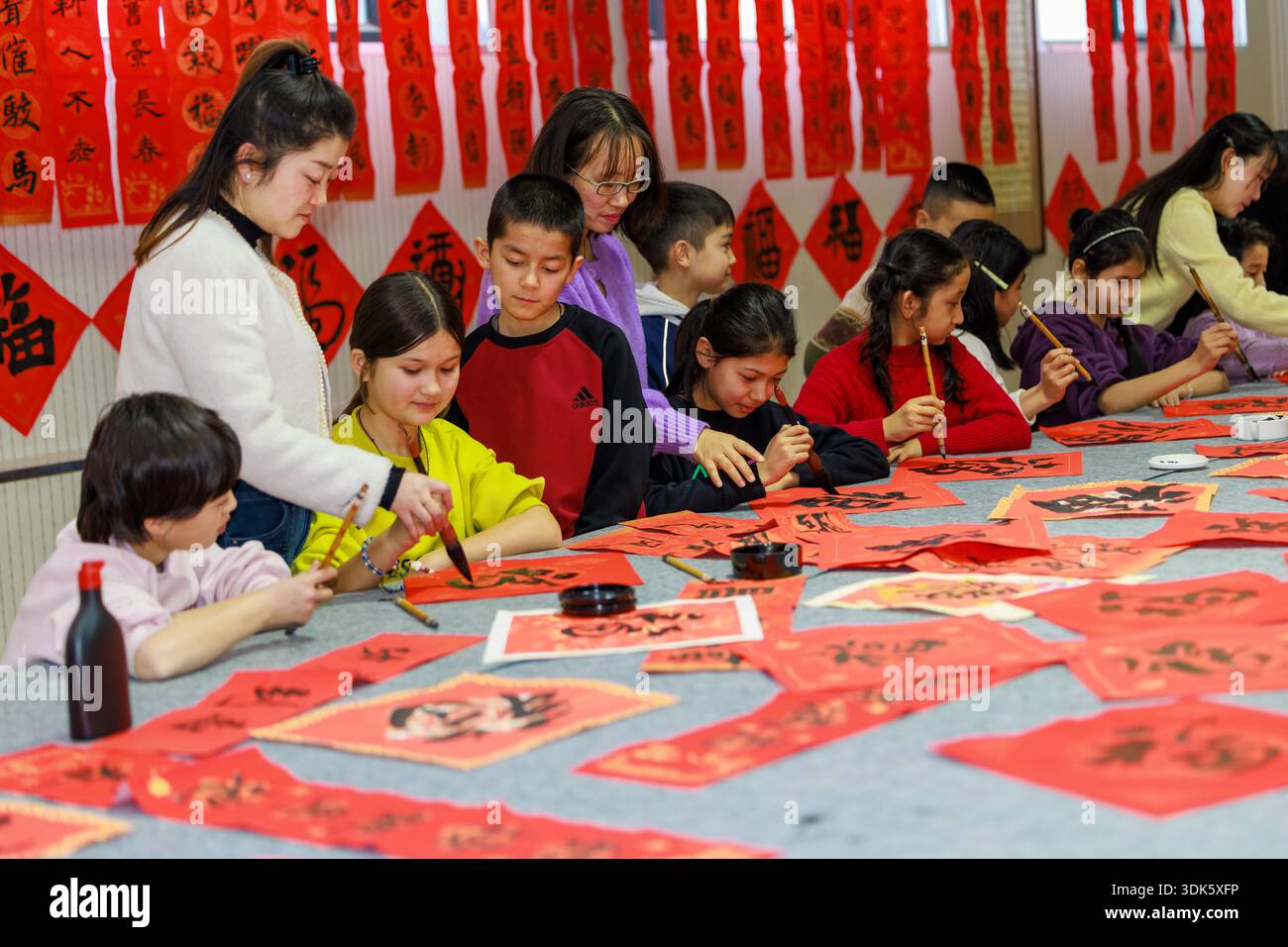 Children and teachers write Spring Festival couplets at a primary ...