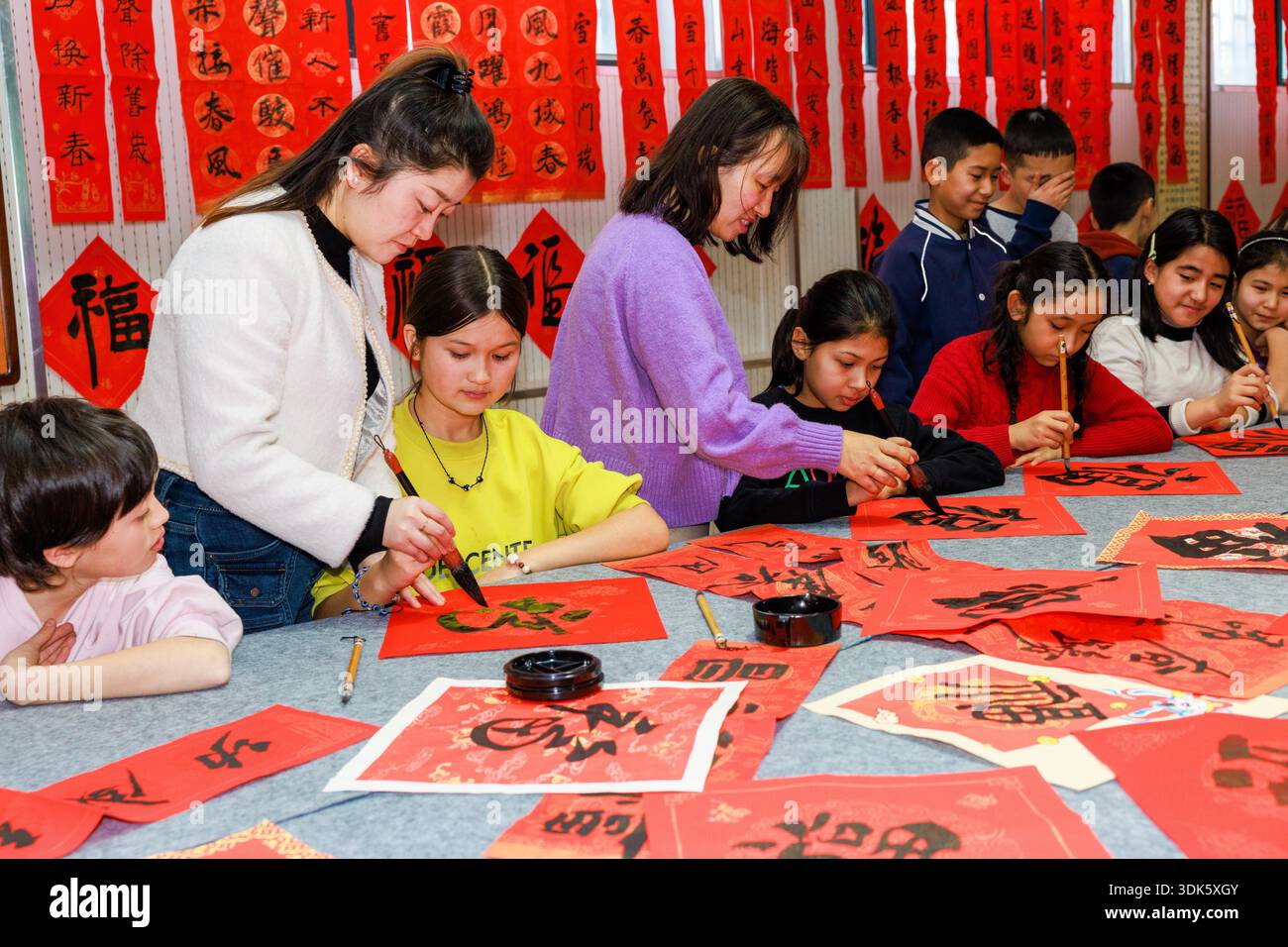 Children and teachers write Spring Festival couplets at a primary ...