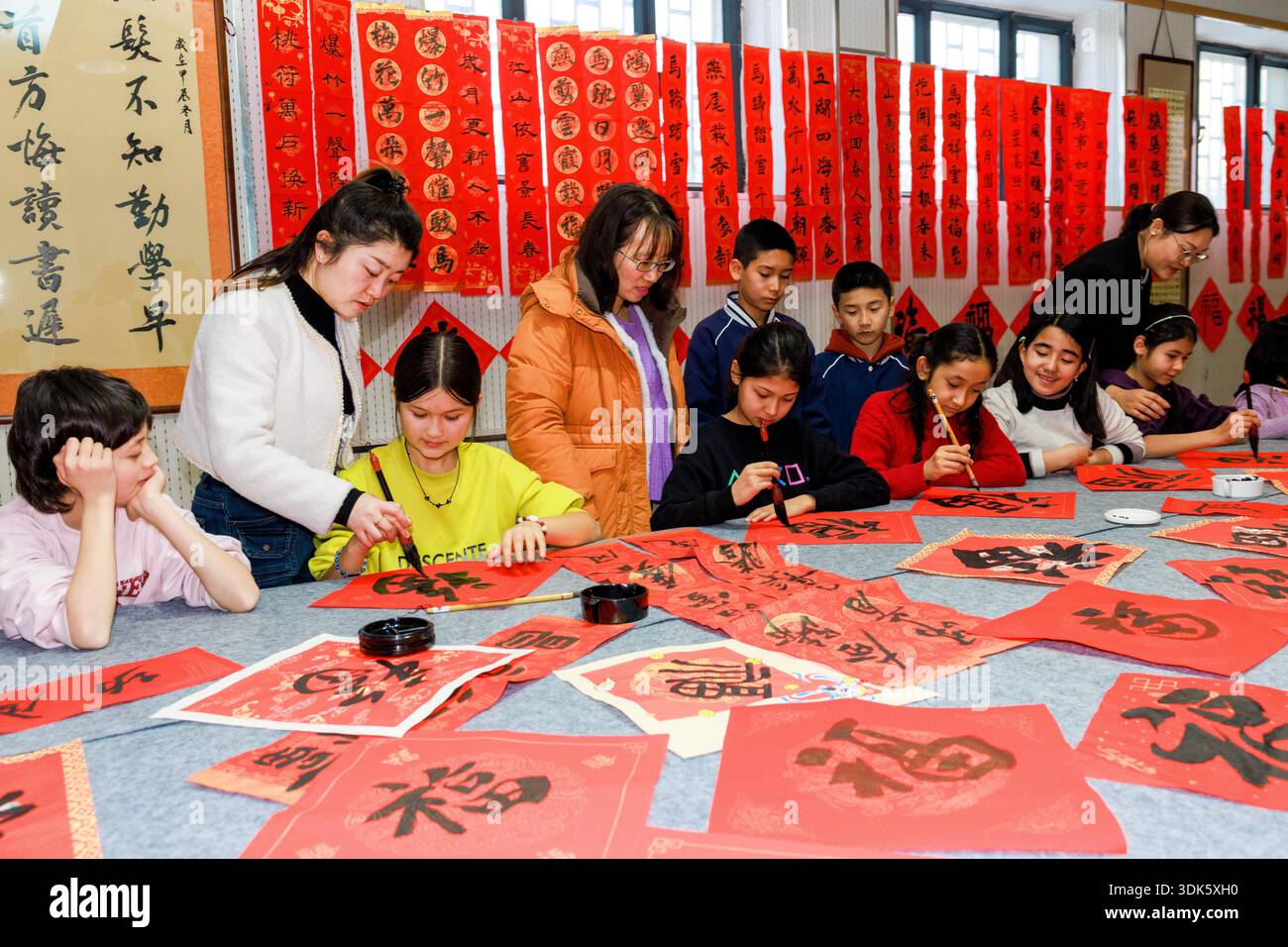 Children and teachers write Spring Festival couplets at a primary ...