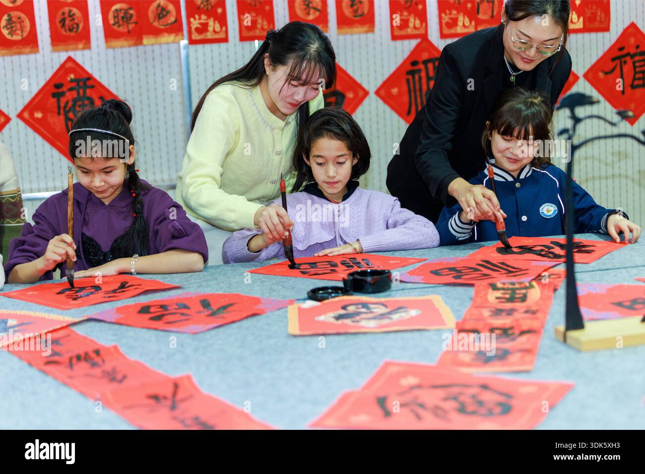 Children and teachers write Spring Festival couplets at a primary ...