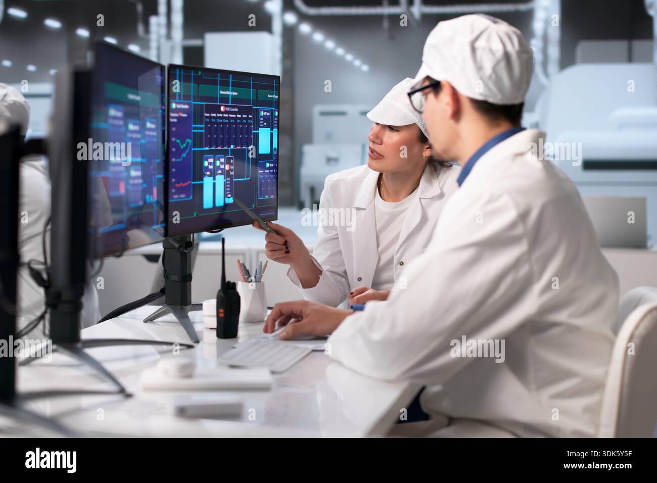 Diverse Team At Automated Manufacturing Plant Uses Computers For ...