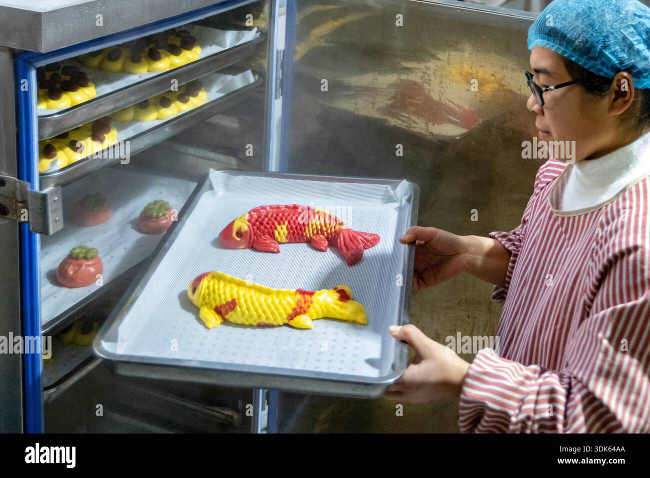 Artisans make colorful flower buns with various shapes at a workshop in ...