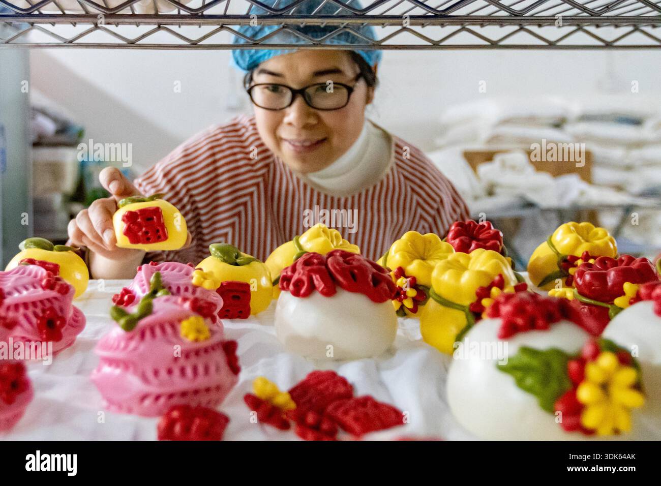 Artisans make colorful flower buns with various shapes at a workshop in ...