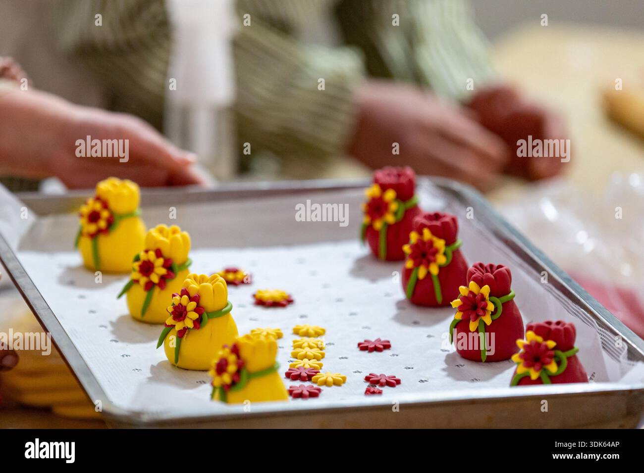 Artisans make colorful flower buns with various shapes at a workshop in ...