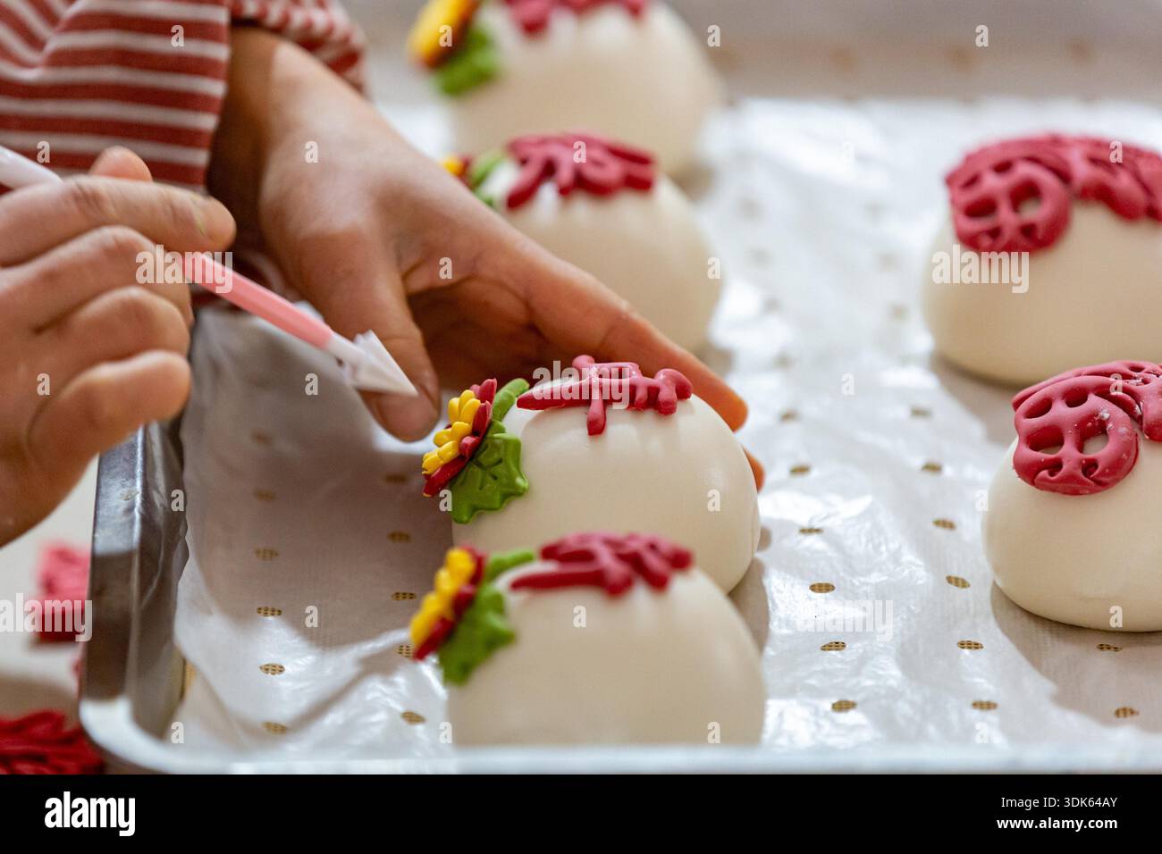 Artisans make colorful flower buns with various shapes at a workshop in ...