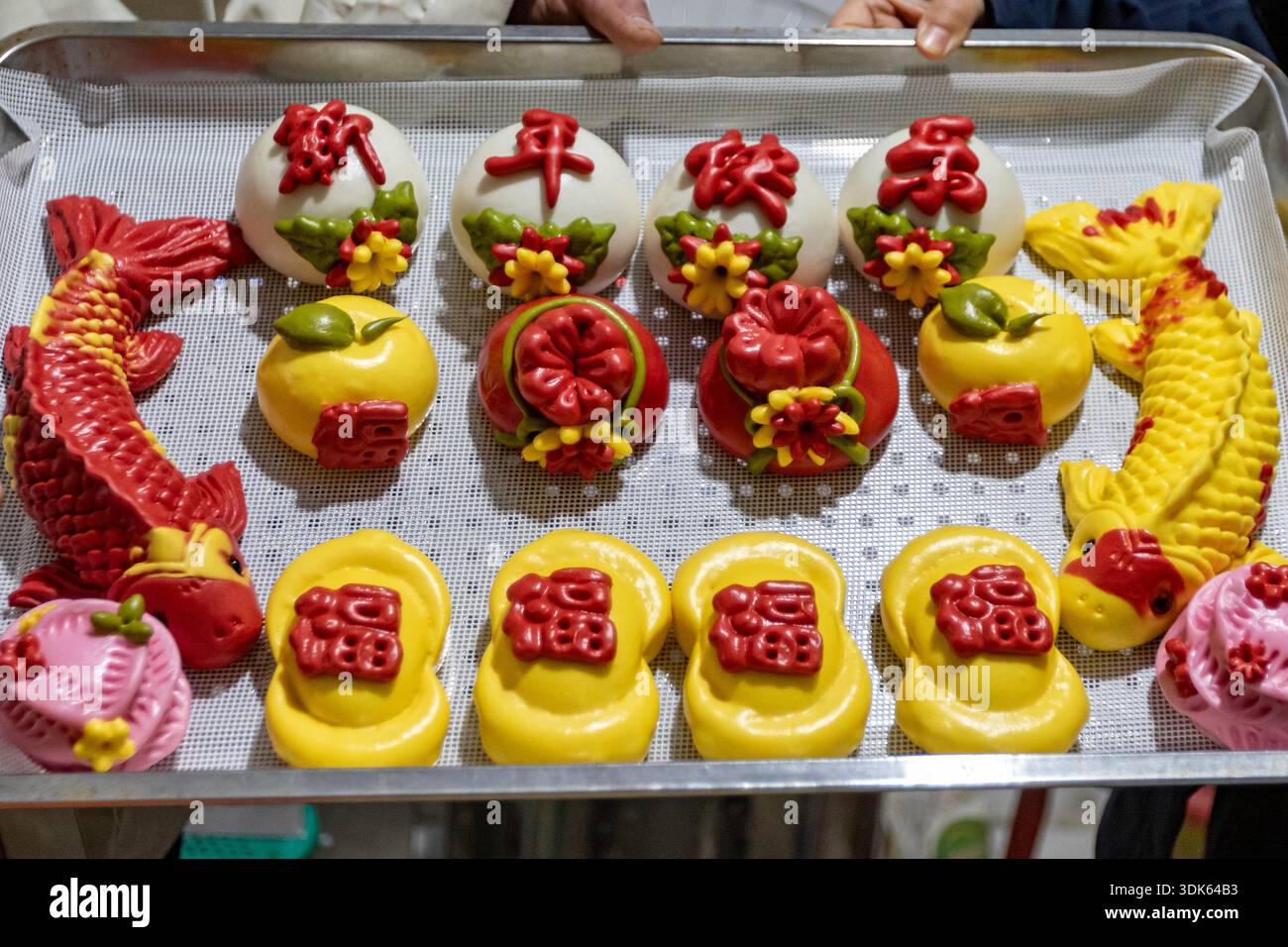 Artisans make colorful flower buns with various shapes at a workshop in ...