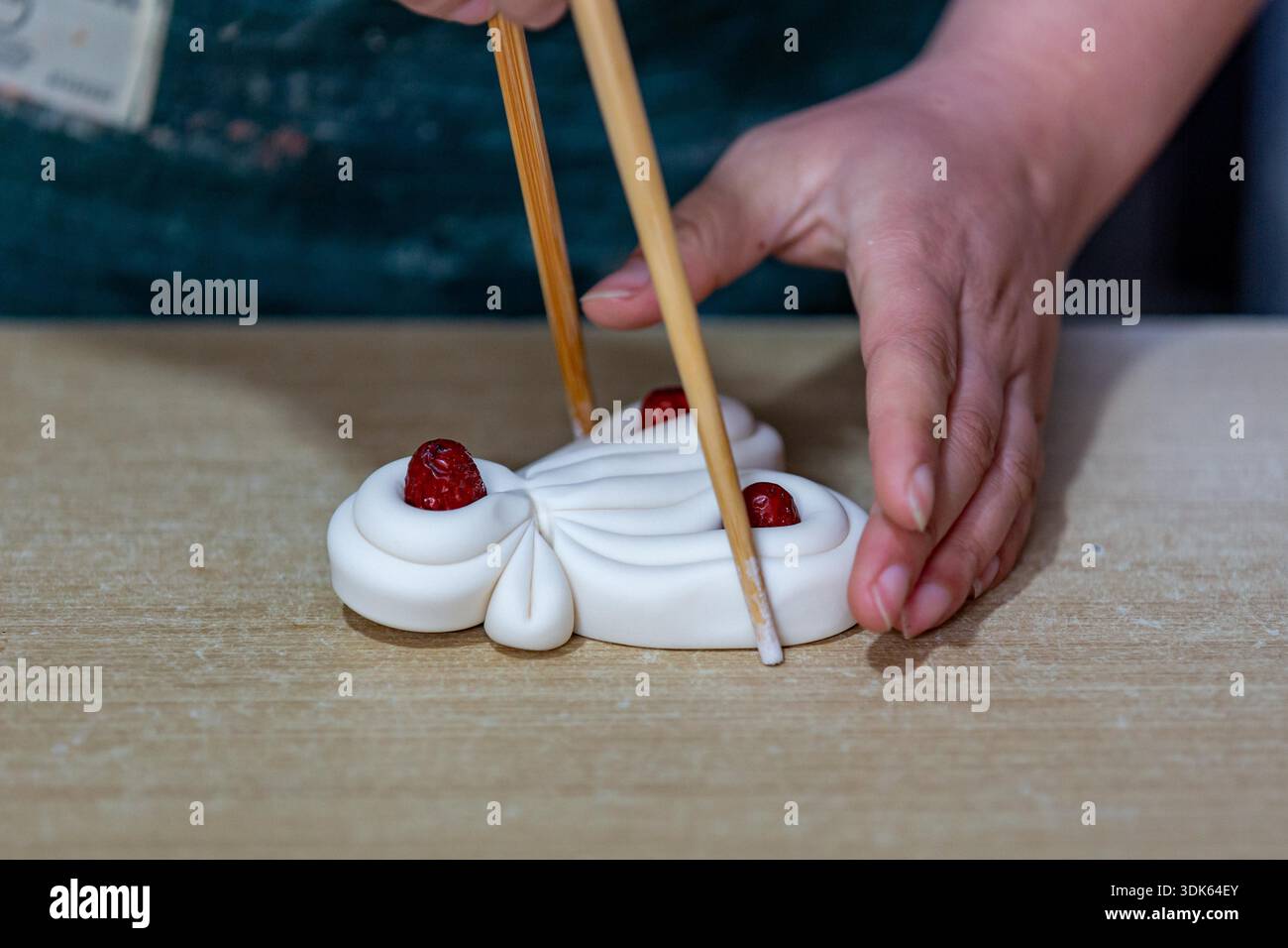 Artisans make colorful flower buns with various shapes at a workshop in ...