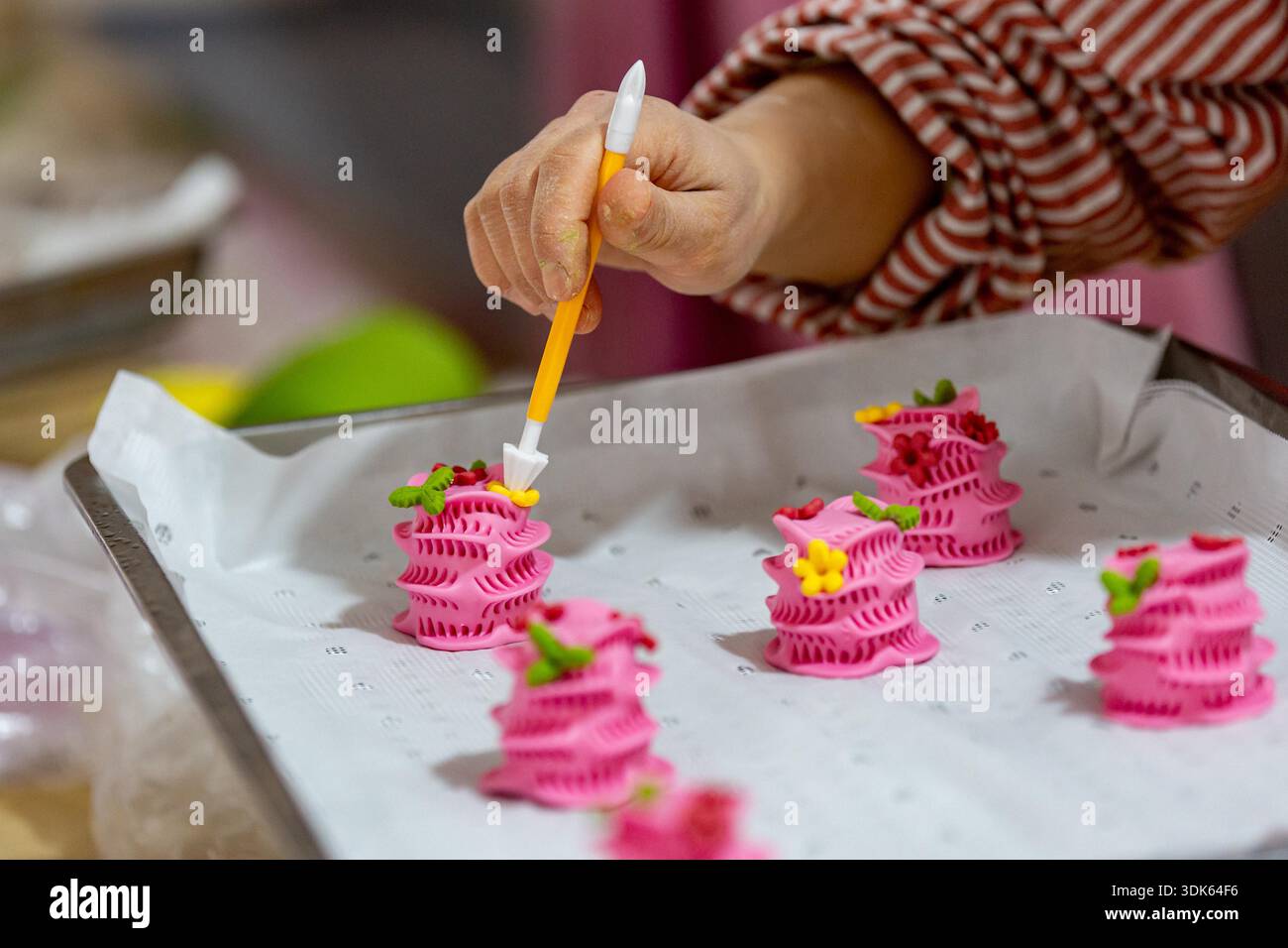 Artisans make colorful flower buns with various shapes at a workshop in ...