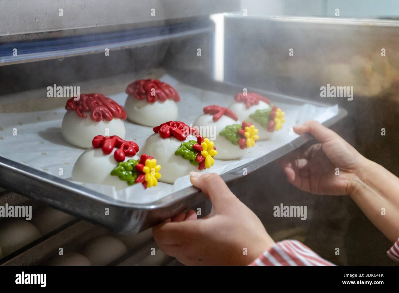 Artisans make colorful flower buns with various shapes at a workshop in ...
