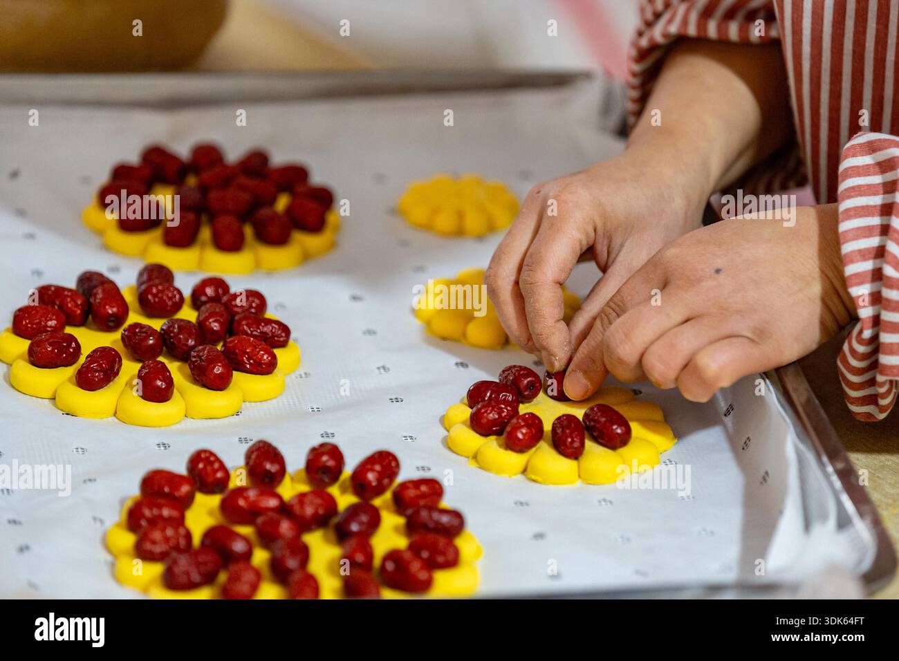 Artisans make colorful flower buns with various shapes at a workshop in ...