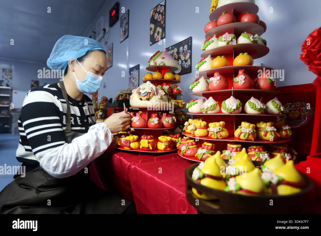 Workers make zodiac-themed festive steamed buns at a workshop in ...