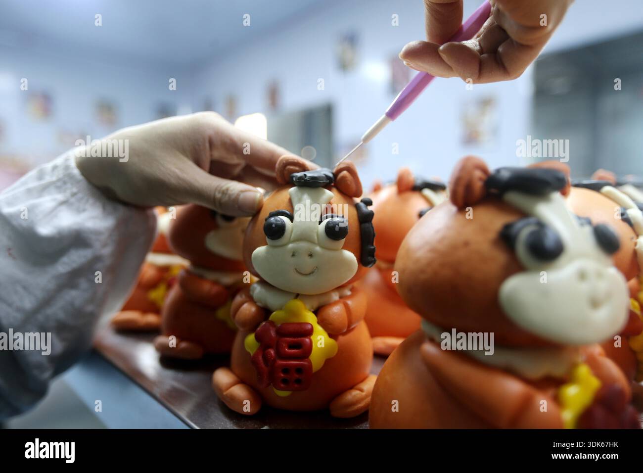 Workers make zodiac-themed festive steamed buns at a workshop in ...