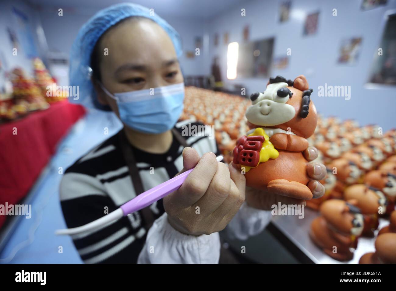 Workers make zodiac-themed festive steamed buns at a workshop in ...