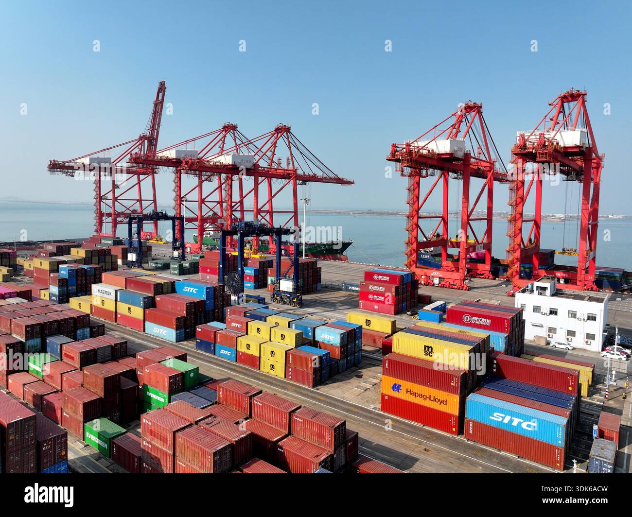 Cargo ships dock at a container terminal in Lianyungang Port ...