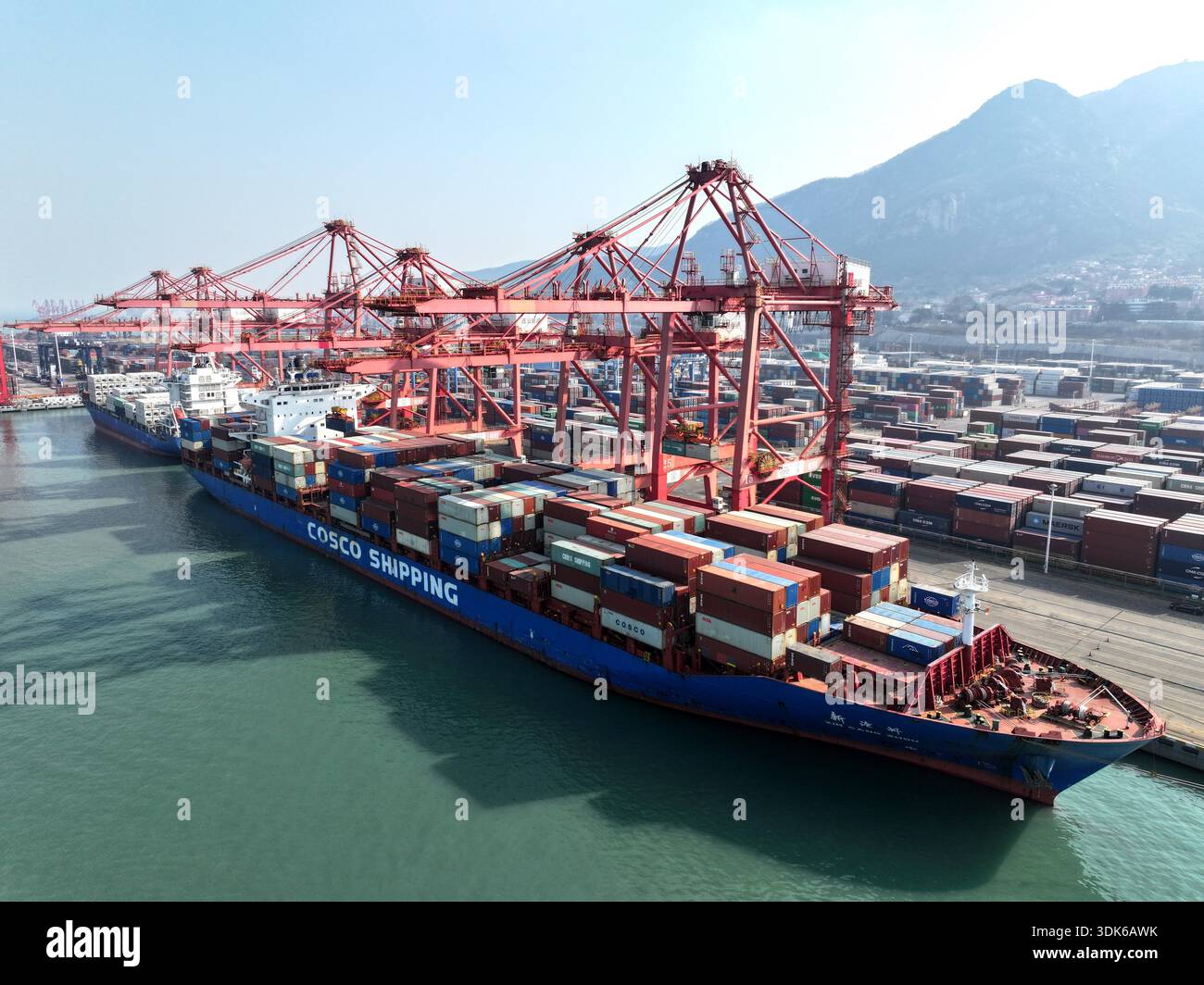 Cargo ships dock at a container terminal in Lianyungang Port ...