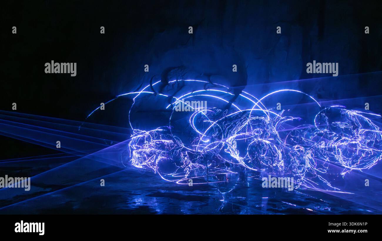 Long exposure abstract composition of glowing blue light trails ...