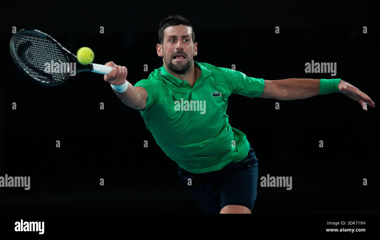 Novak Djokovic of Serbia plays a forehand return to Jannik Sinner of ...