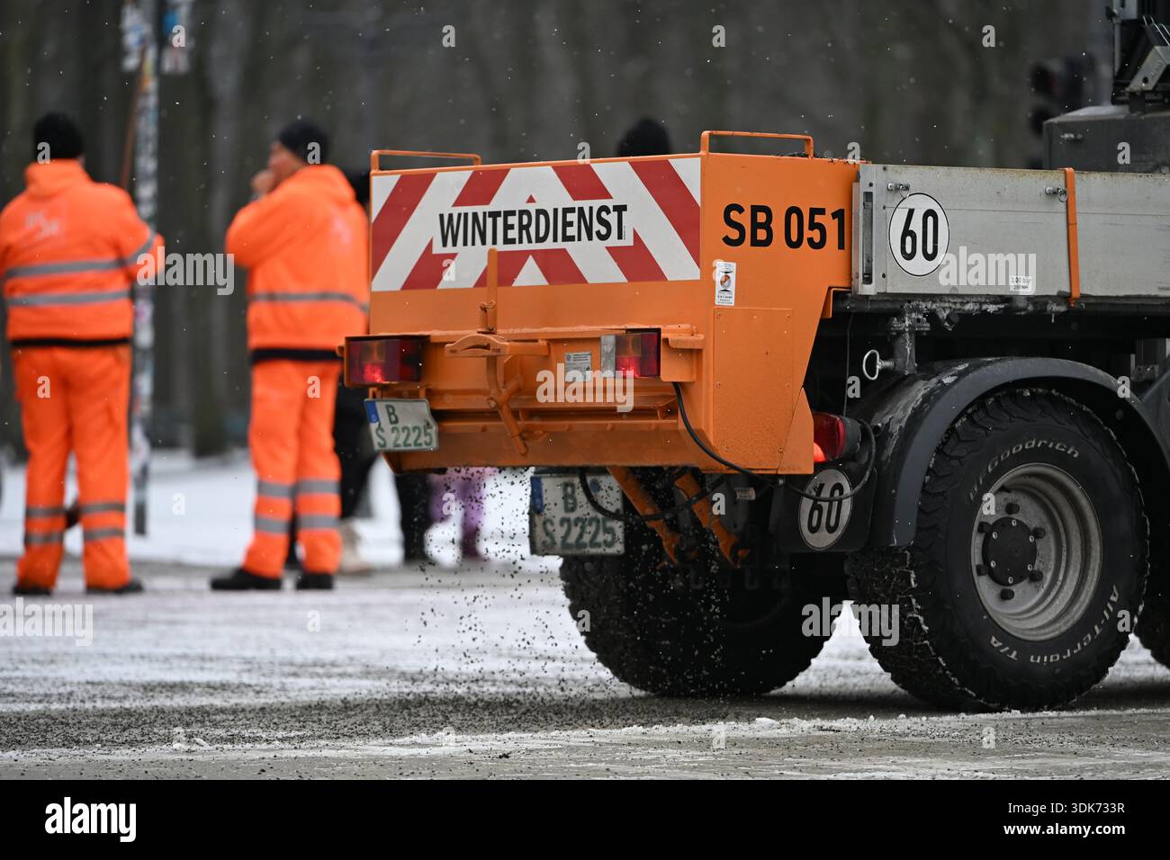 30 January 2026, Berlin: A vehicle from the winter road clearance ...