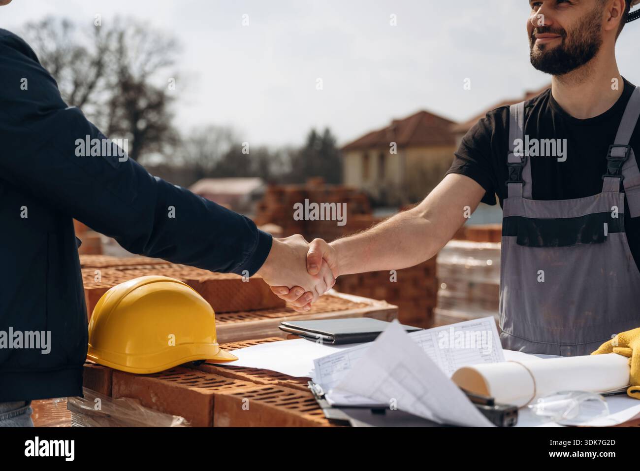 Handshake, making a deal. Cooperation between construction site worker ...