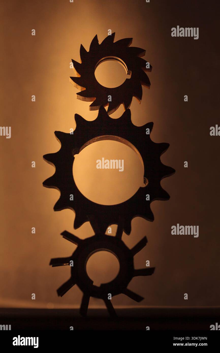 Wheels as gears, a balanced stack of three different metal cog wheels ...