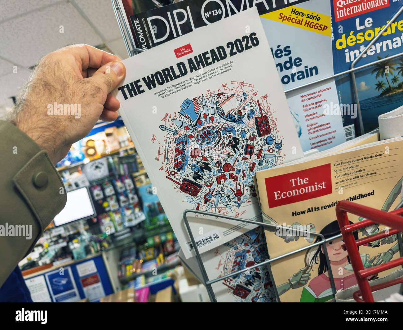 Paris, France - Dec 8, 2025: POV hand holding The World Ahead 2026 ...