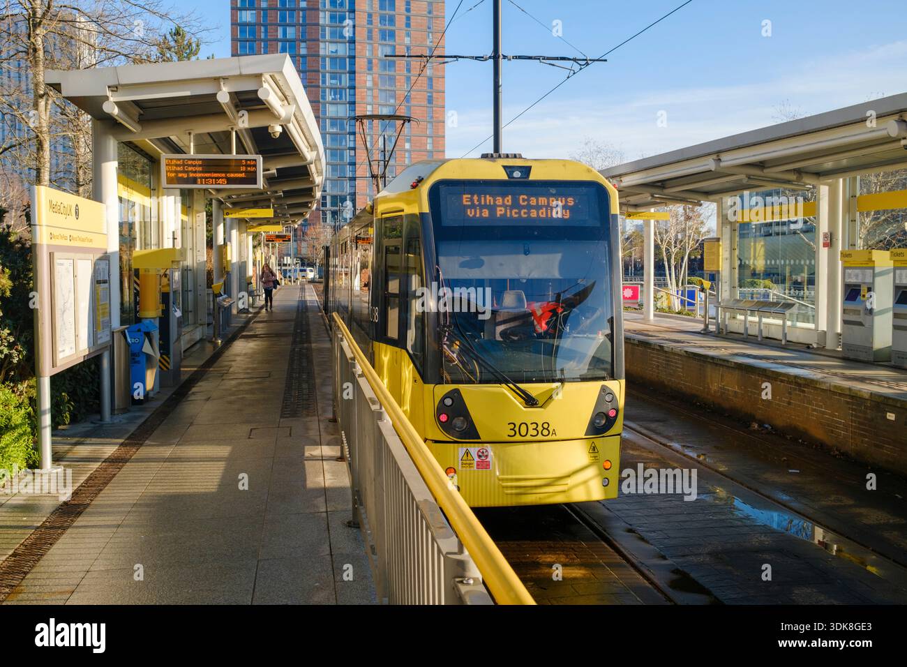 A yellow tram on the Metrolink network in Manchester. This is at the ...