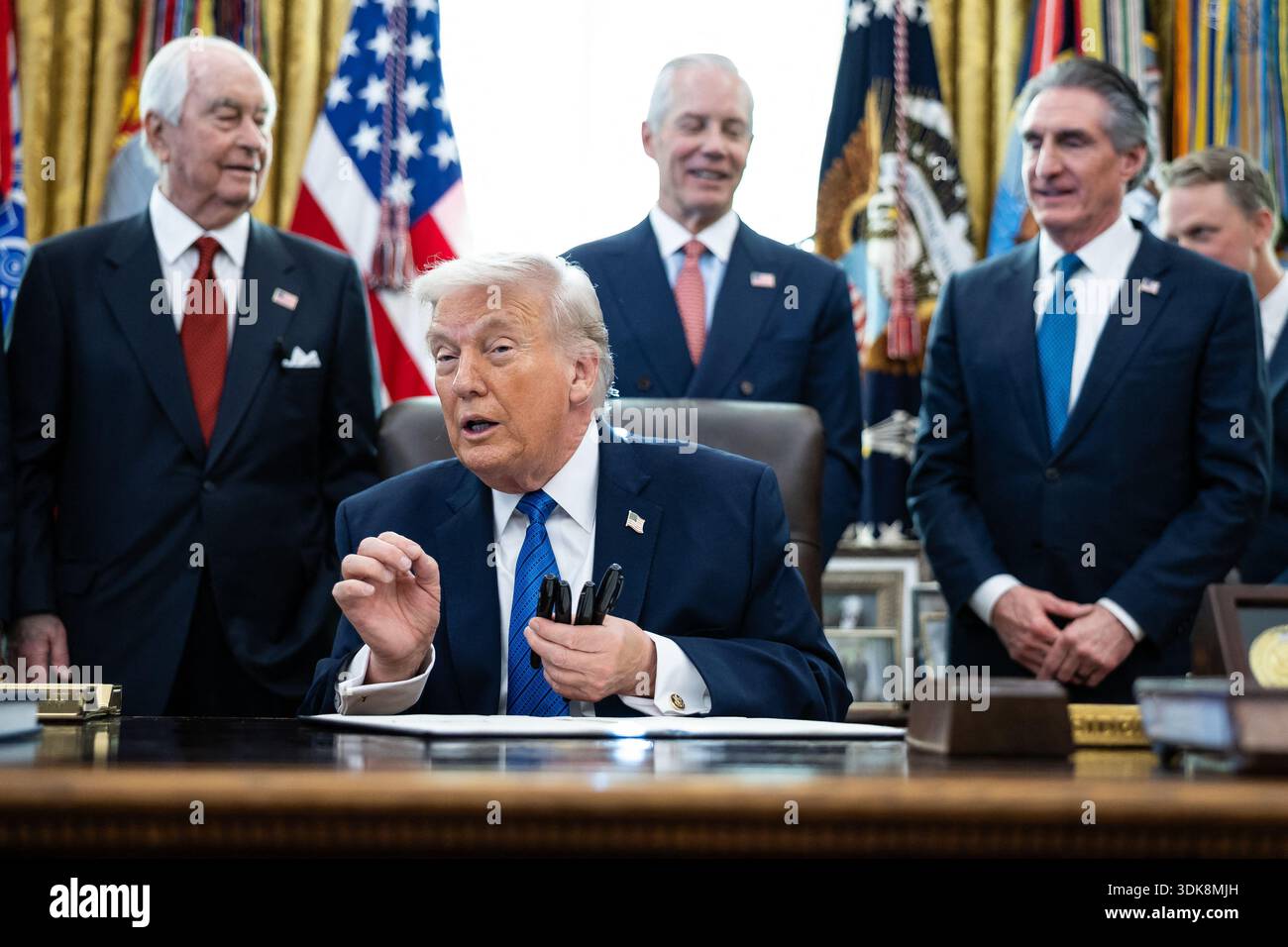 President Donald Trump signs executive orders in the Oval Office at the ...