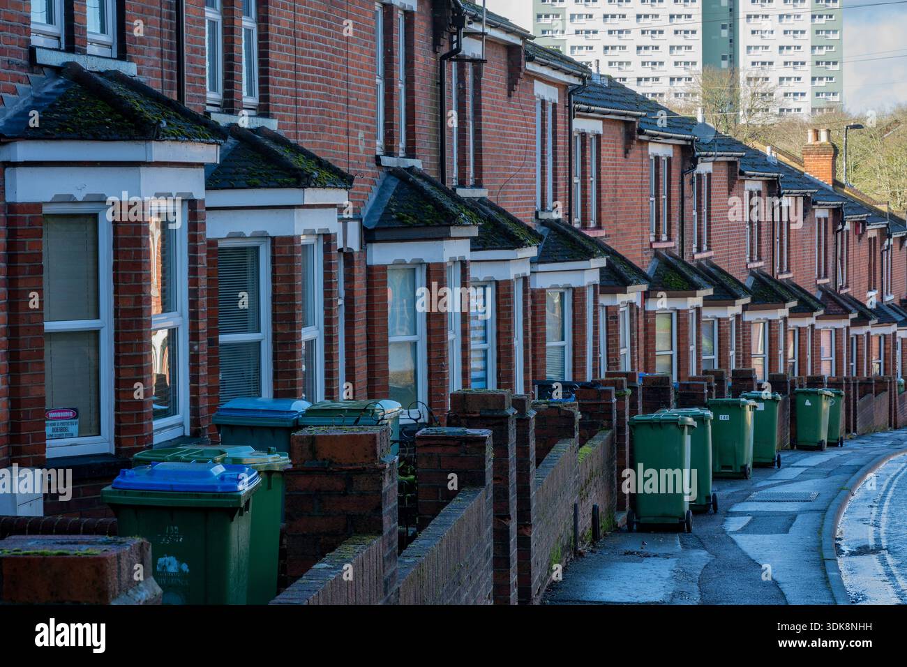 Row of typical red brick city centre terraced houses with plastic ...