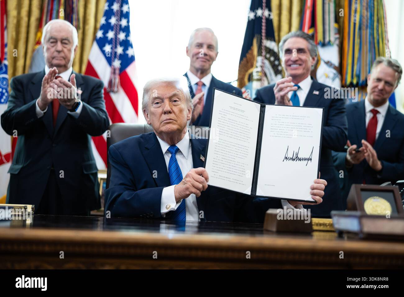President Donald Trump signs executive orders in the Oval Office at the ...
