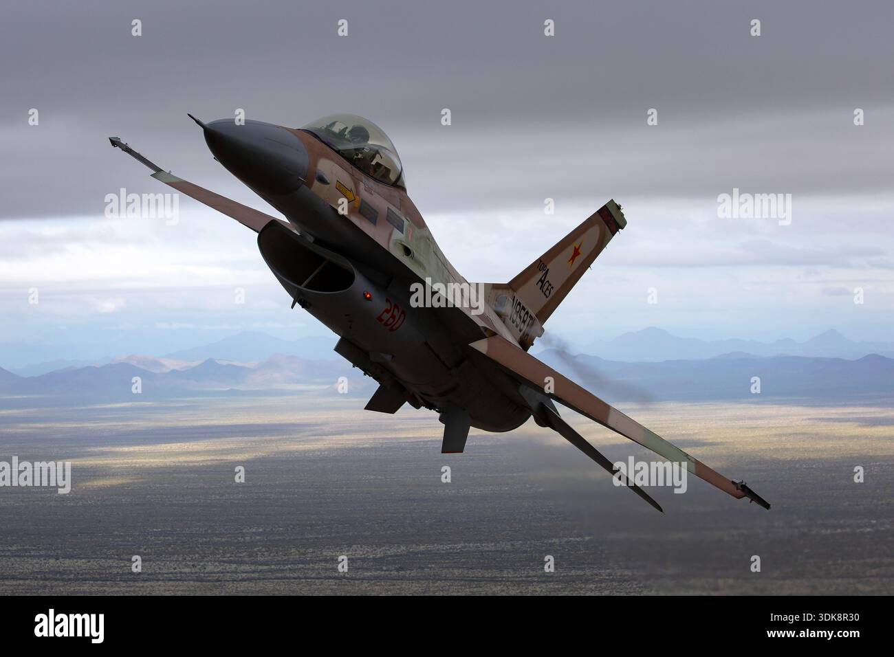 A close air-to-air view shows a camouflaged F-16A Netz operated by Top ...