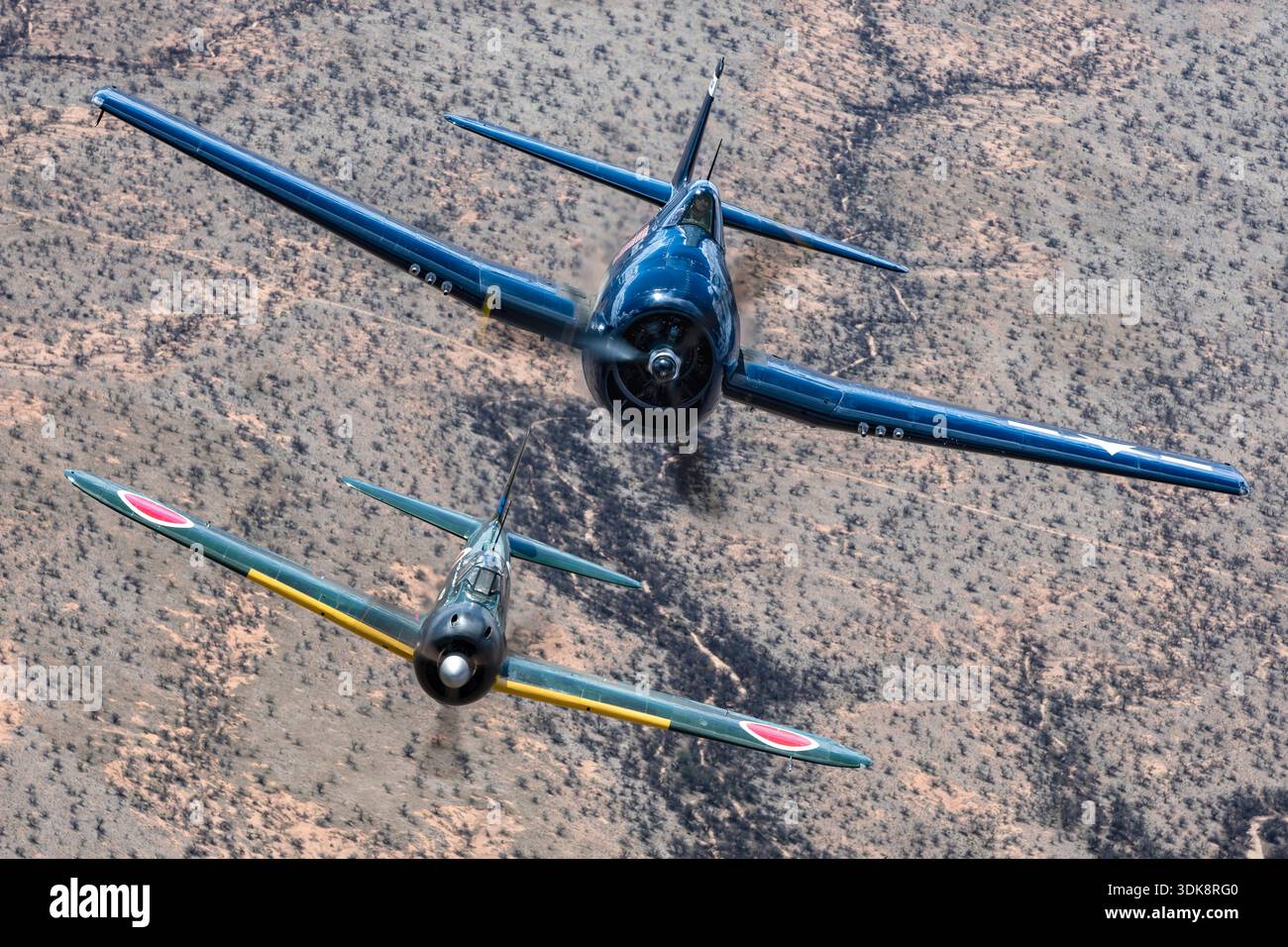 A Mitsubishi A6M3 Reisen and a Grumman F6F-5 Hellcat fly in close ...